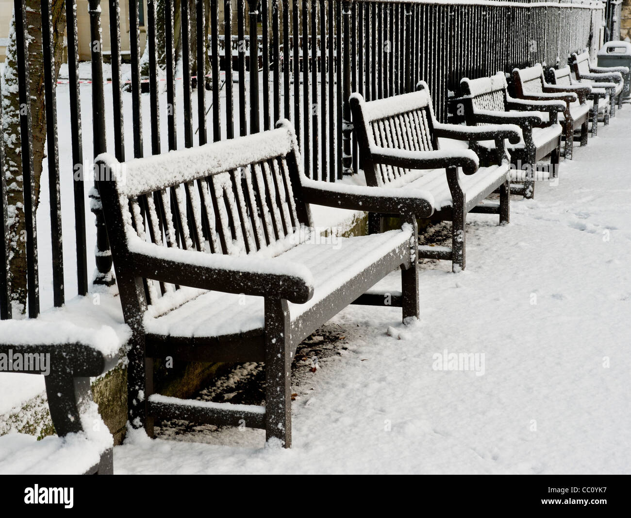 Snow covered park benches in Stock Photo - Alamy