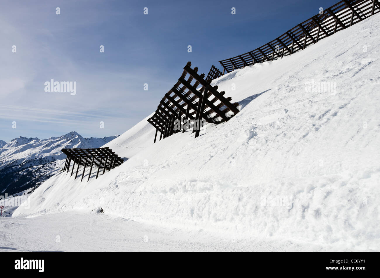 Snow control barriers protecting the piste ski slope below from ...