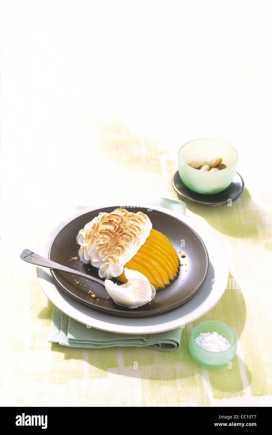 Slices of mango au gratin with meringue Stock Photo - Alamy