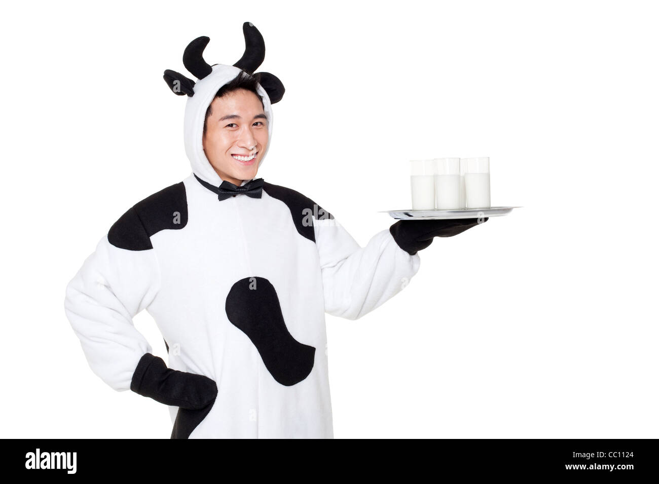 Man in cow costume with a serving tray of milk Stock Photo - Alamy