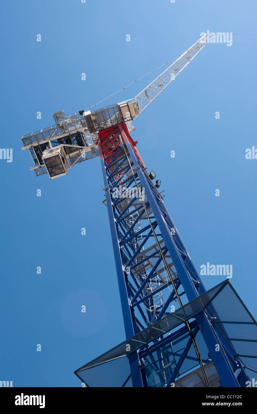 Looking up at a tall construction crane on a building site in England ...