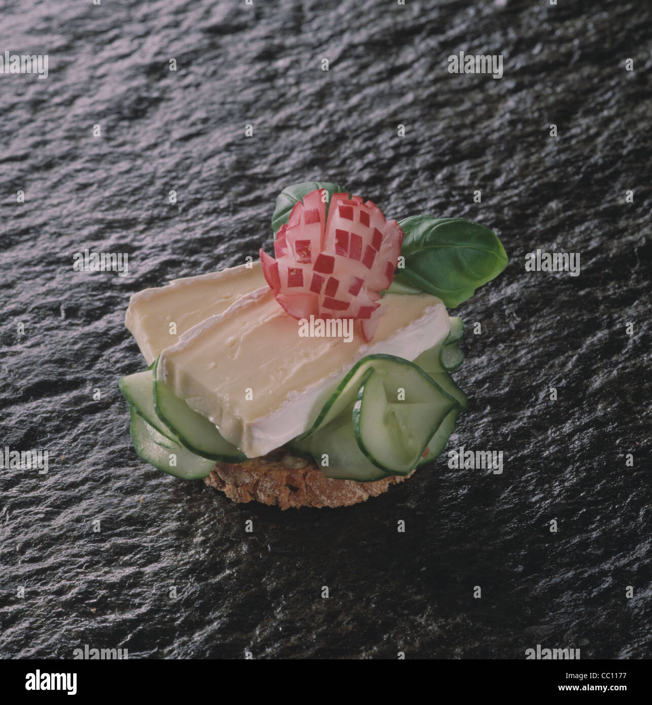Still: Brie (cheese) with radish flower Stock Photo - Alamy
