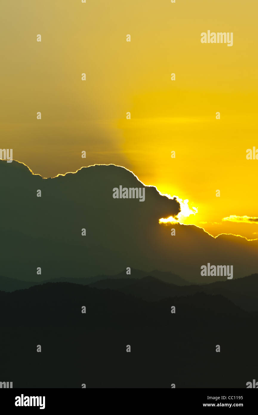 Sunset behind mountains with golden color Stock Photo - Alamy