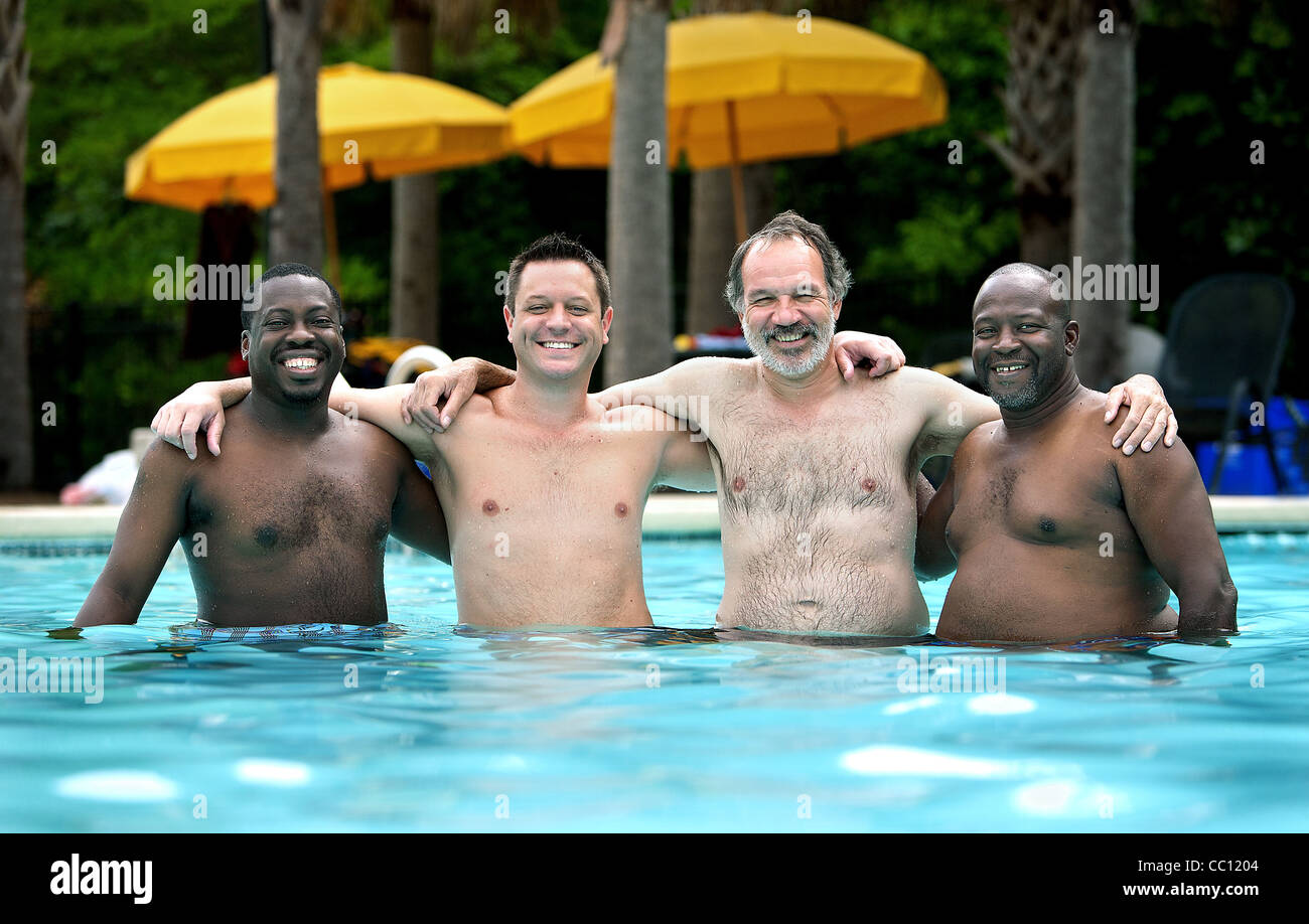 Four men enjoy themselves in a pool Stock Photo - Alamy