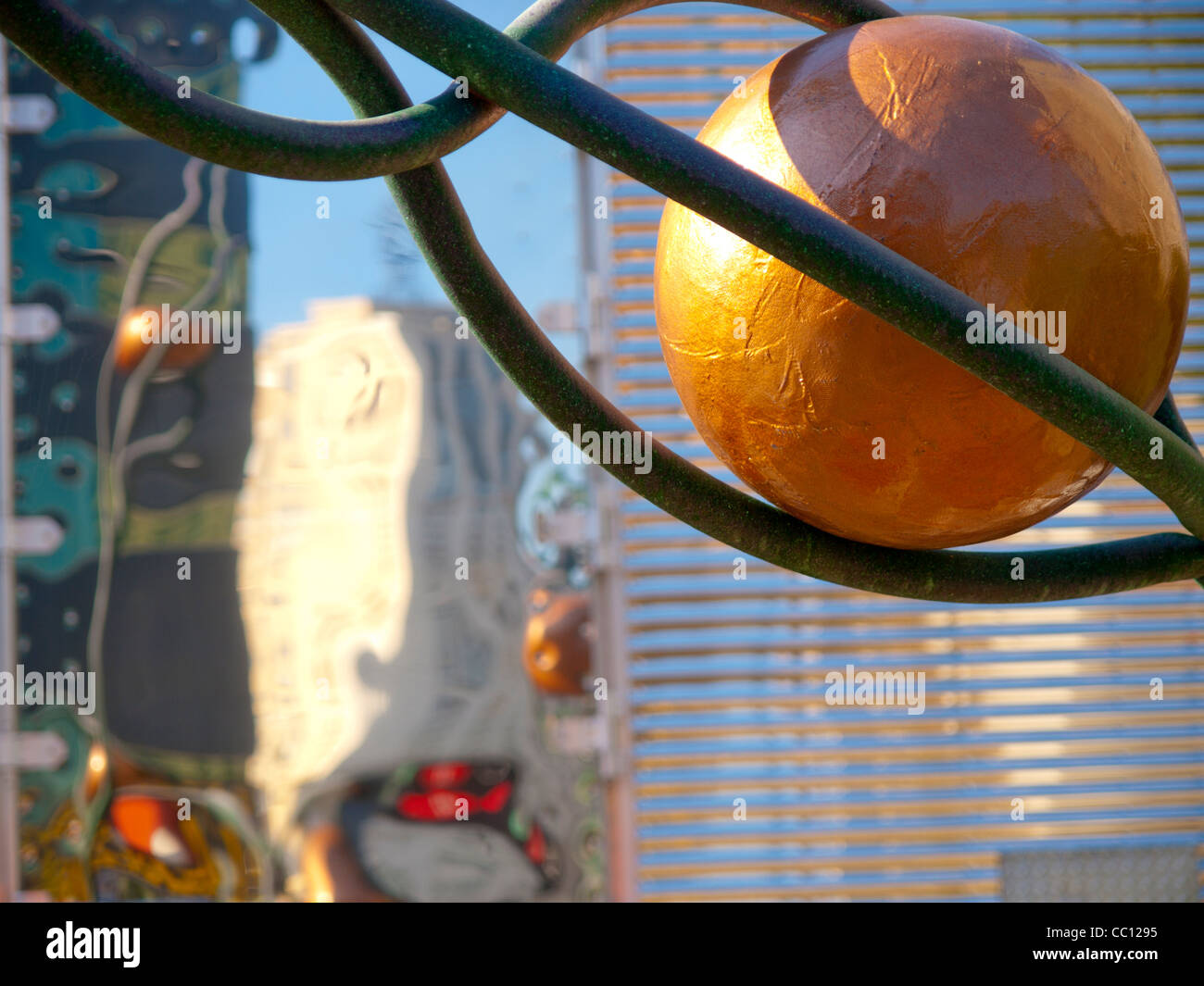 The metal sculpture Seed Pods by Joshua Wambaugh is reflected in the ...