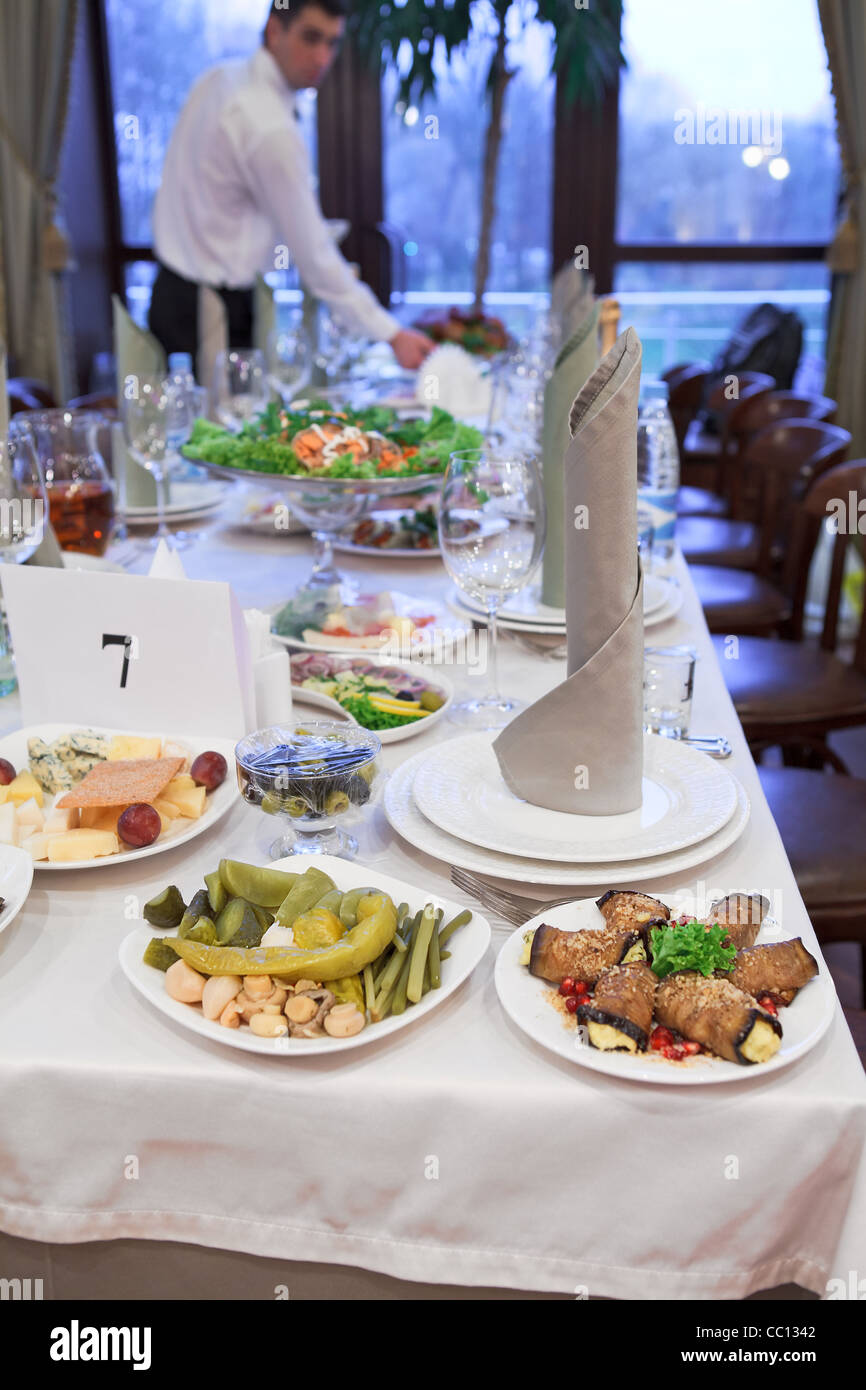 Unrecognizable person setting the table in a restaurant. Catering ...