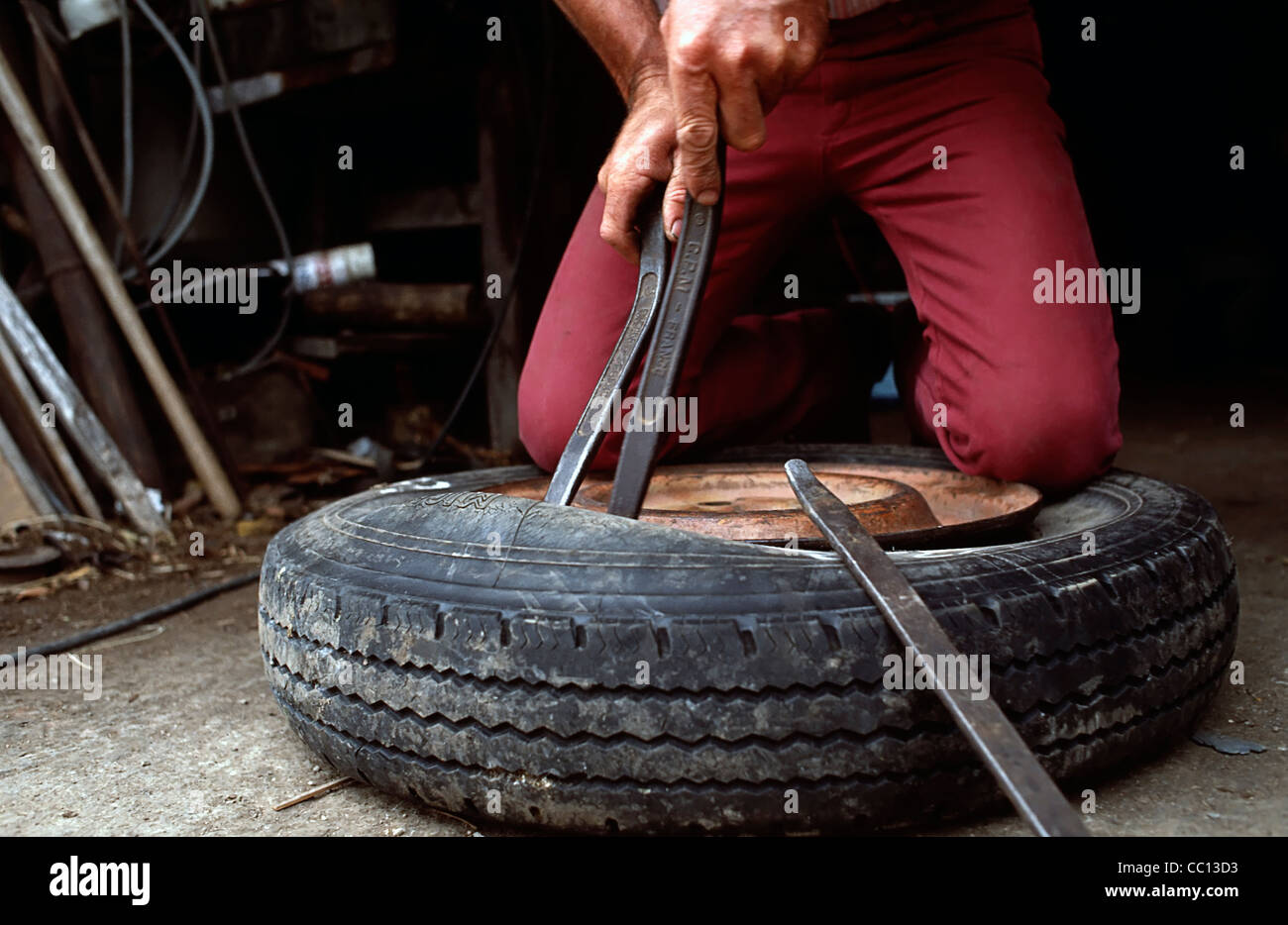 Man Repairing Flat Tire Stock Photo - Alamy