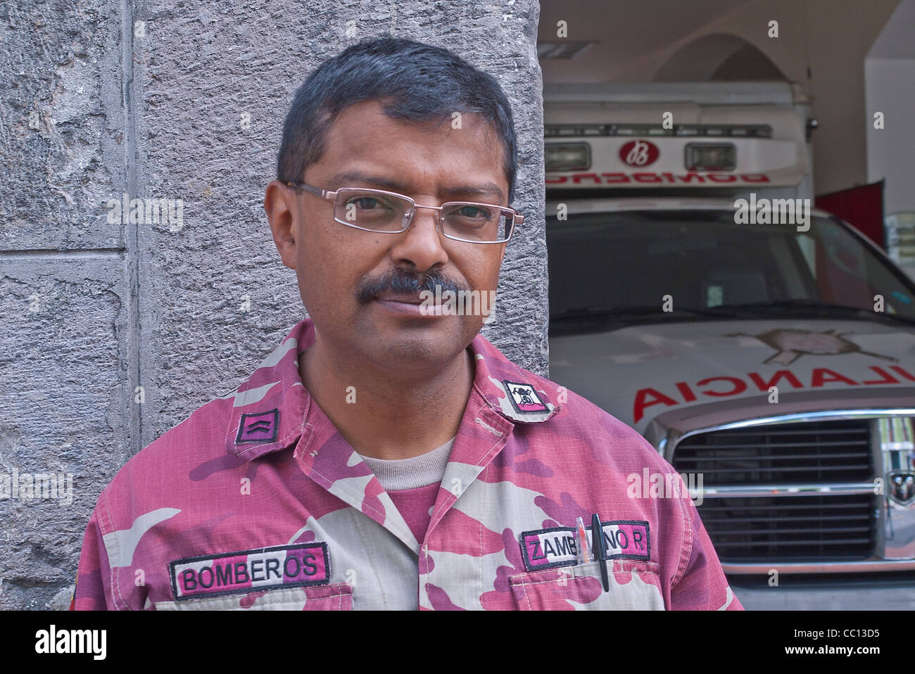 One mulato firefighter, in his red and gray camouflage uniform standing ...