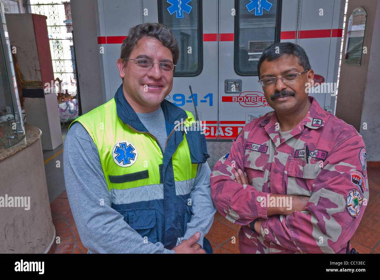 Two men, one fire fighter and one paramedic stand in front of their ...