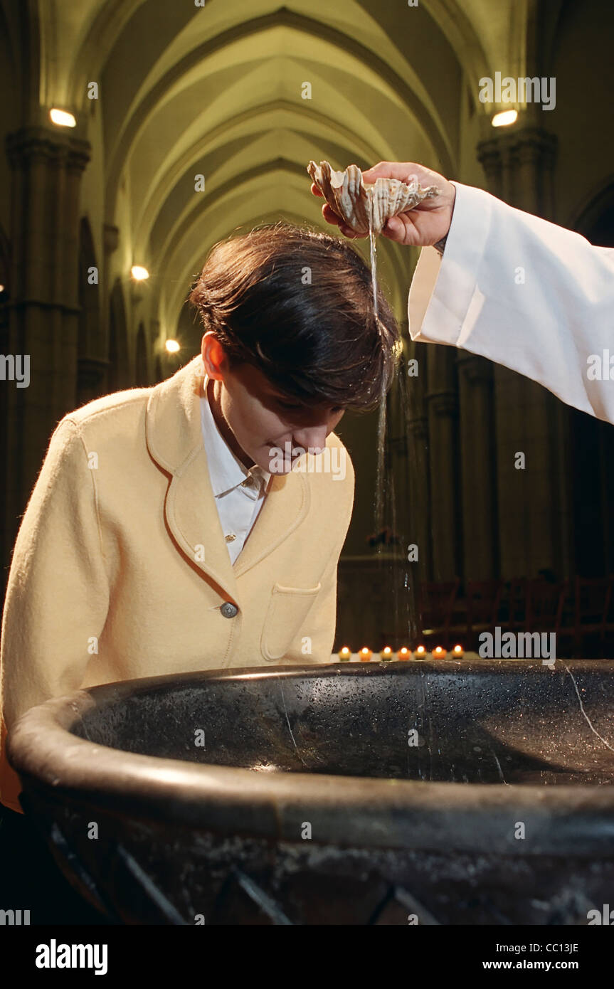 Christian baptism Sacrament of a woman - anointing the supplicant’s head with holy water Stock ...