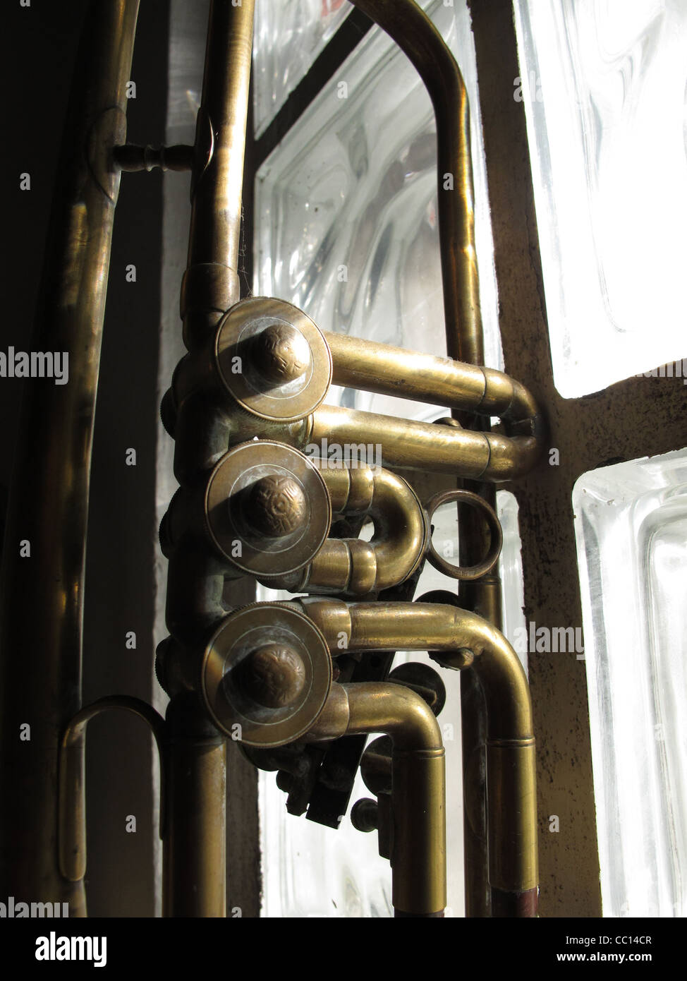 old brass horn trumpet music instrument by window Stock Photo - Alamy