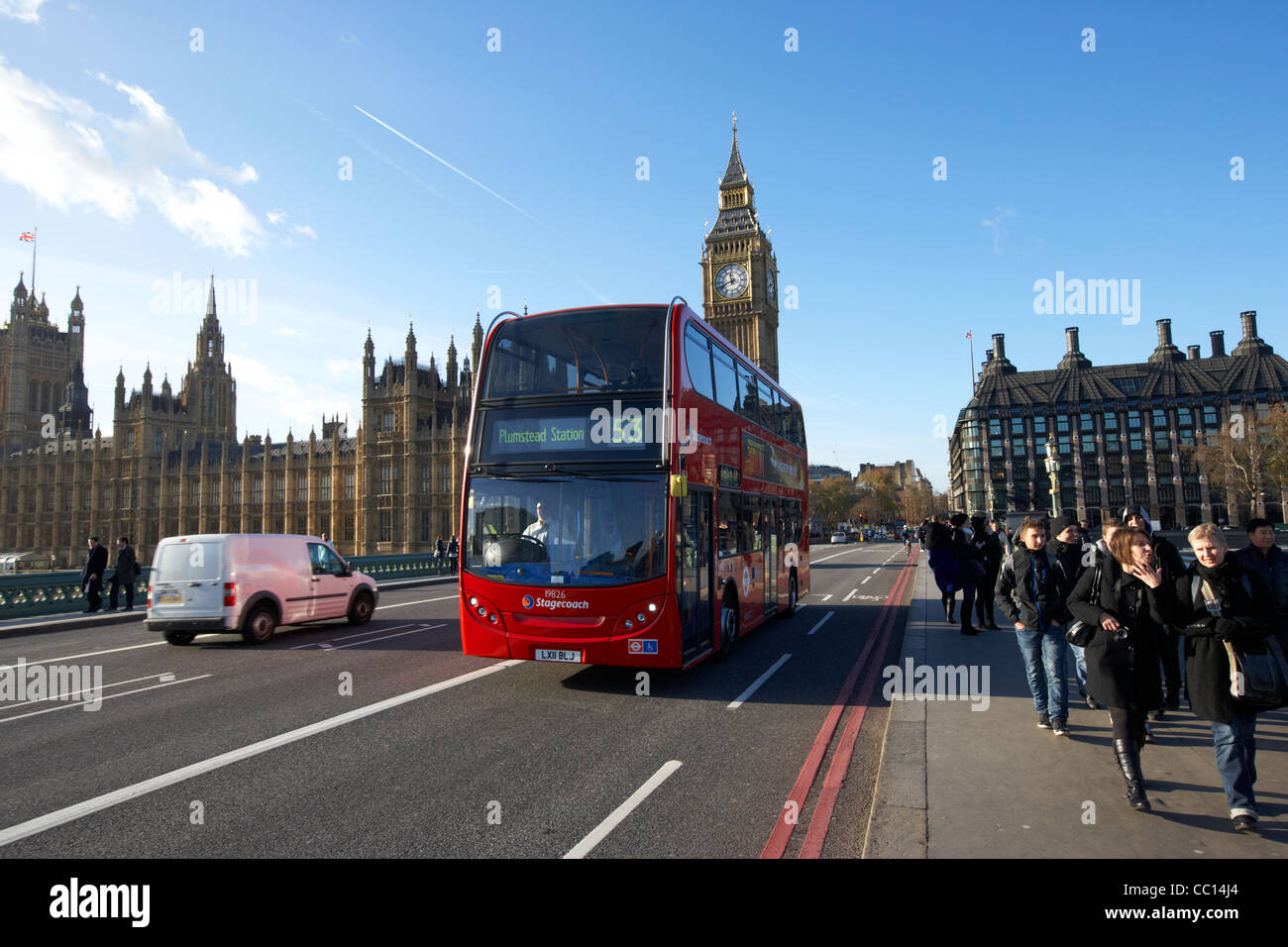 red london bus crossing westminster bridge at the palace of westminster ...