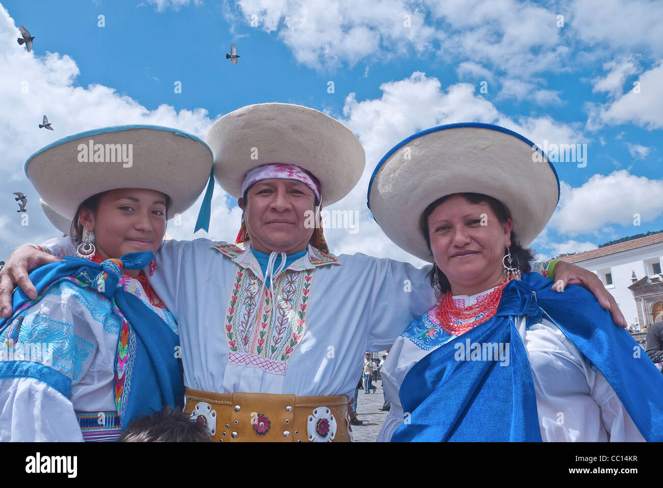 Three Hispanic dancers from Grupo Folclorico face the camera in ...