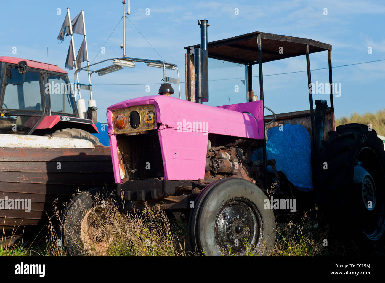 Pretty pink tractor on standby Stock Photo - Alamy