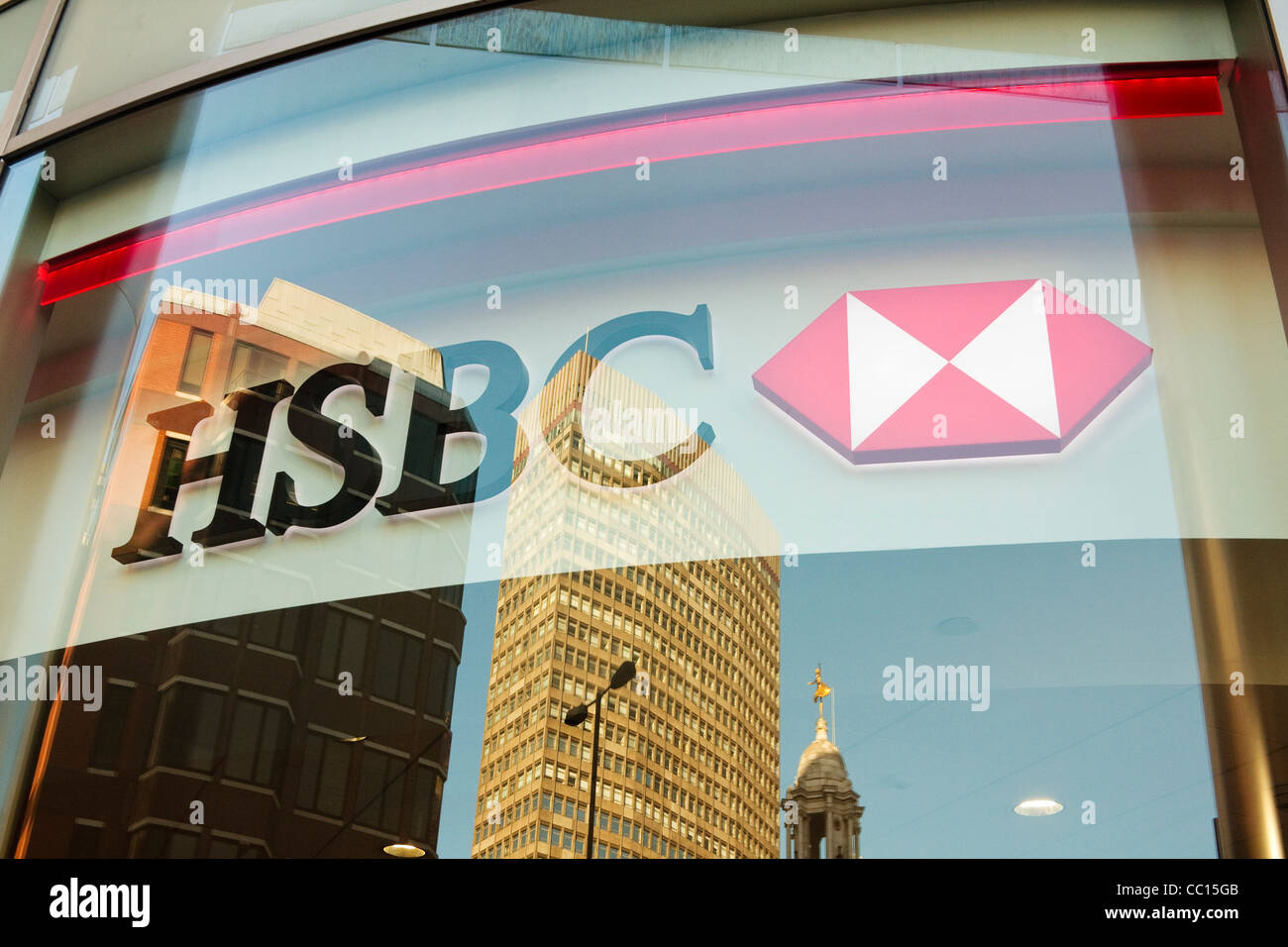 An HSBC shop front sign set against reflections of office buildings ...
