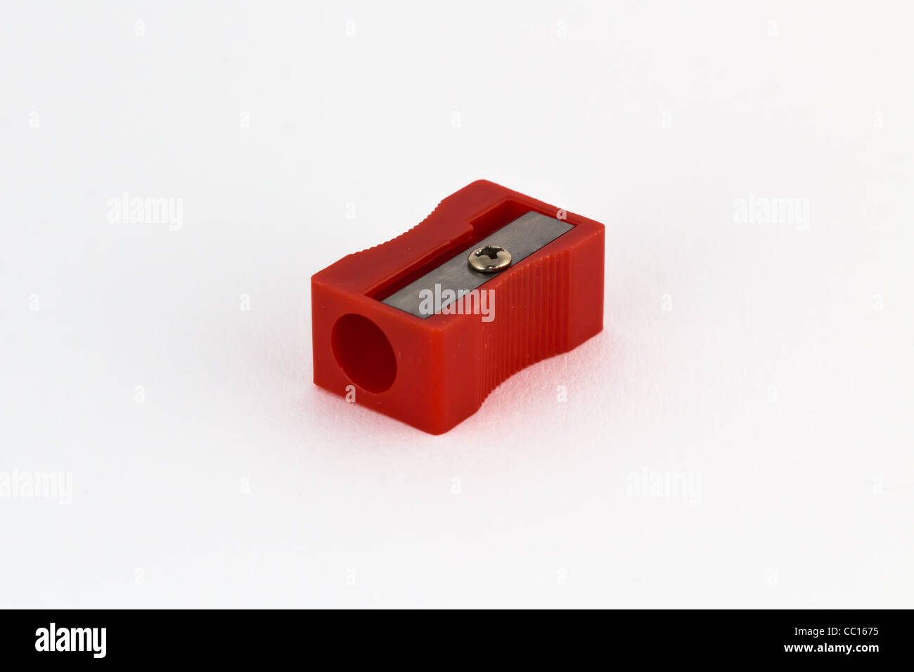 A red pencil sharpener on white background Stock Photo - Alamy