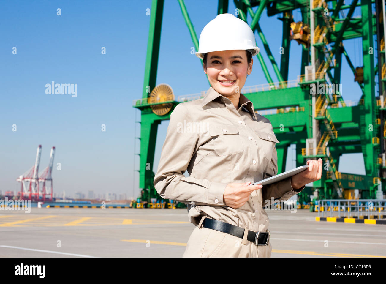 Female shipping industry worker with clipboard Stock Photo - Alamy