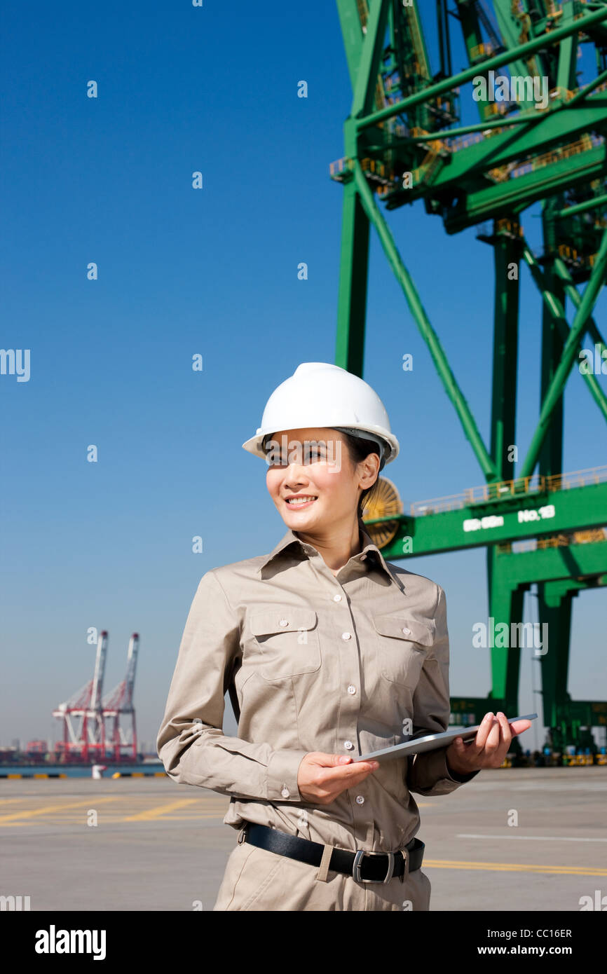 Female shipping industry worker with clipboard Stock Photo - Alamy