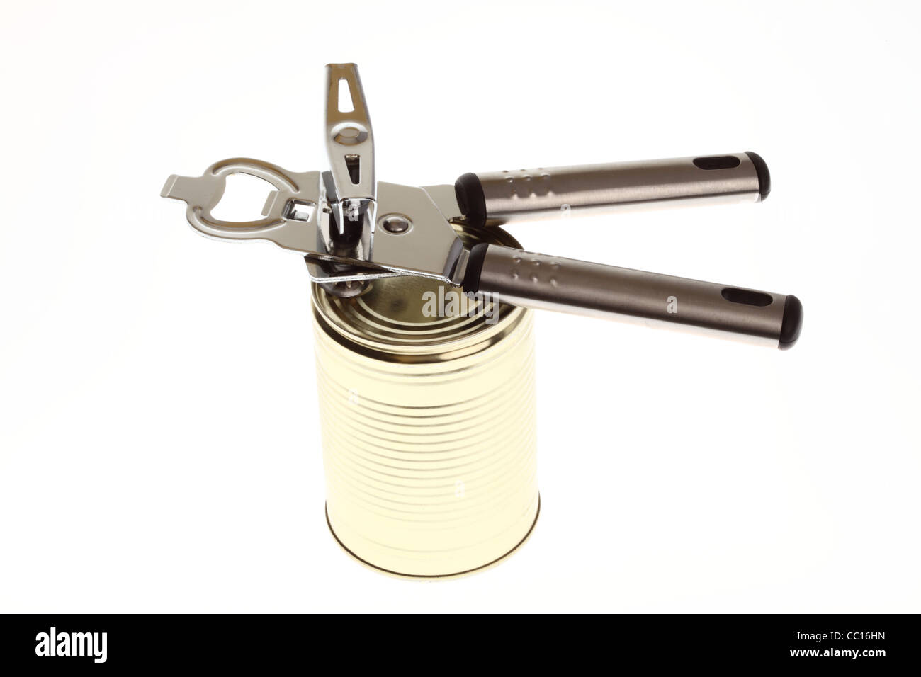 Tin opener opening a can of food isolated on white Stock Photo - Alamy