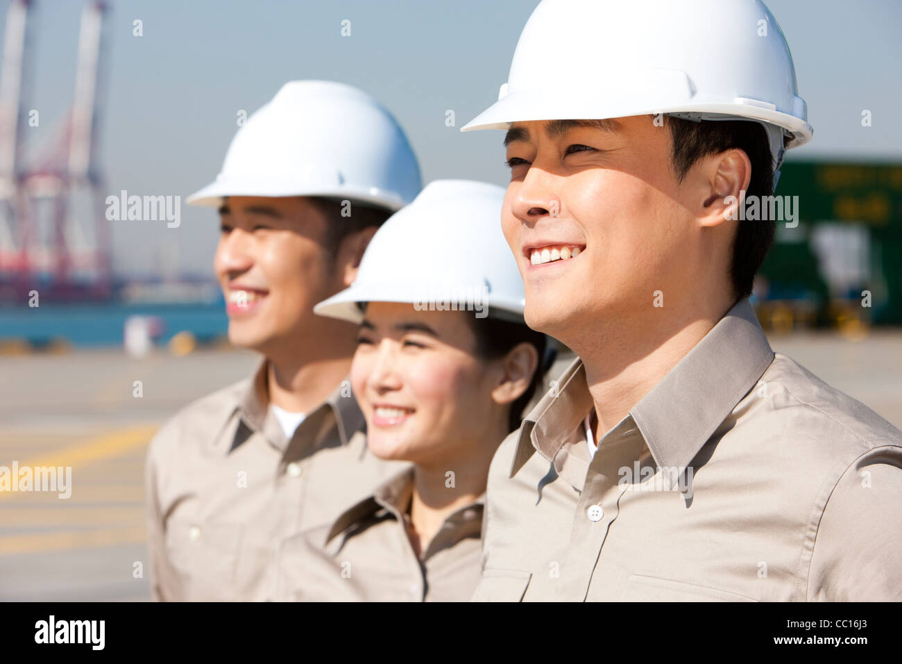 shipping industry workers looking in the distance Stock Photo - Alamy