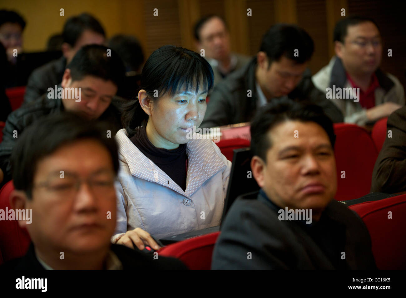 A female cadre student uses laptop while attending a lecture in Beijing ...