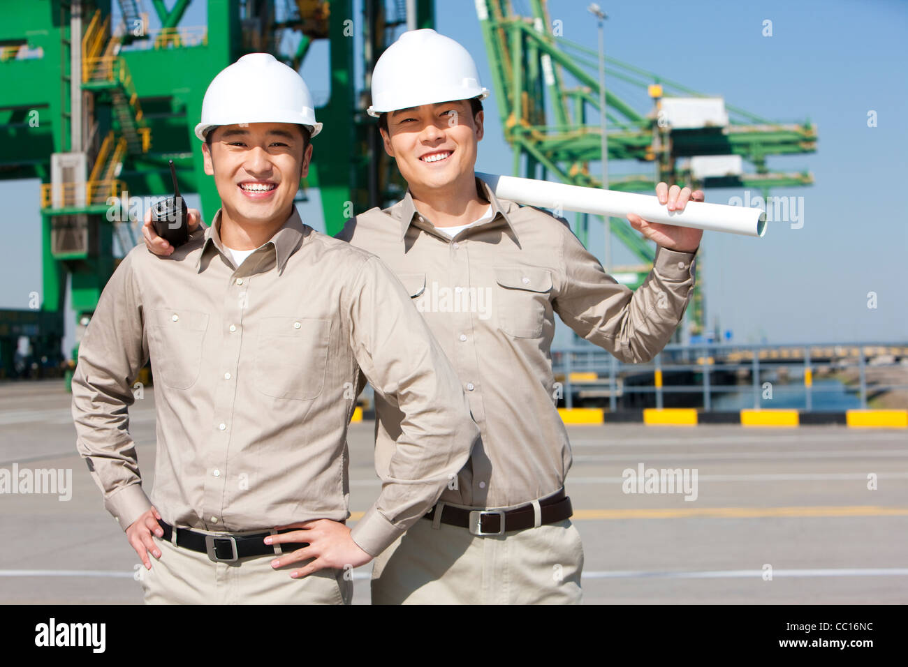 Male shipping industry workers smiling Stock Photo - Alamy