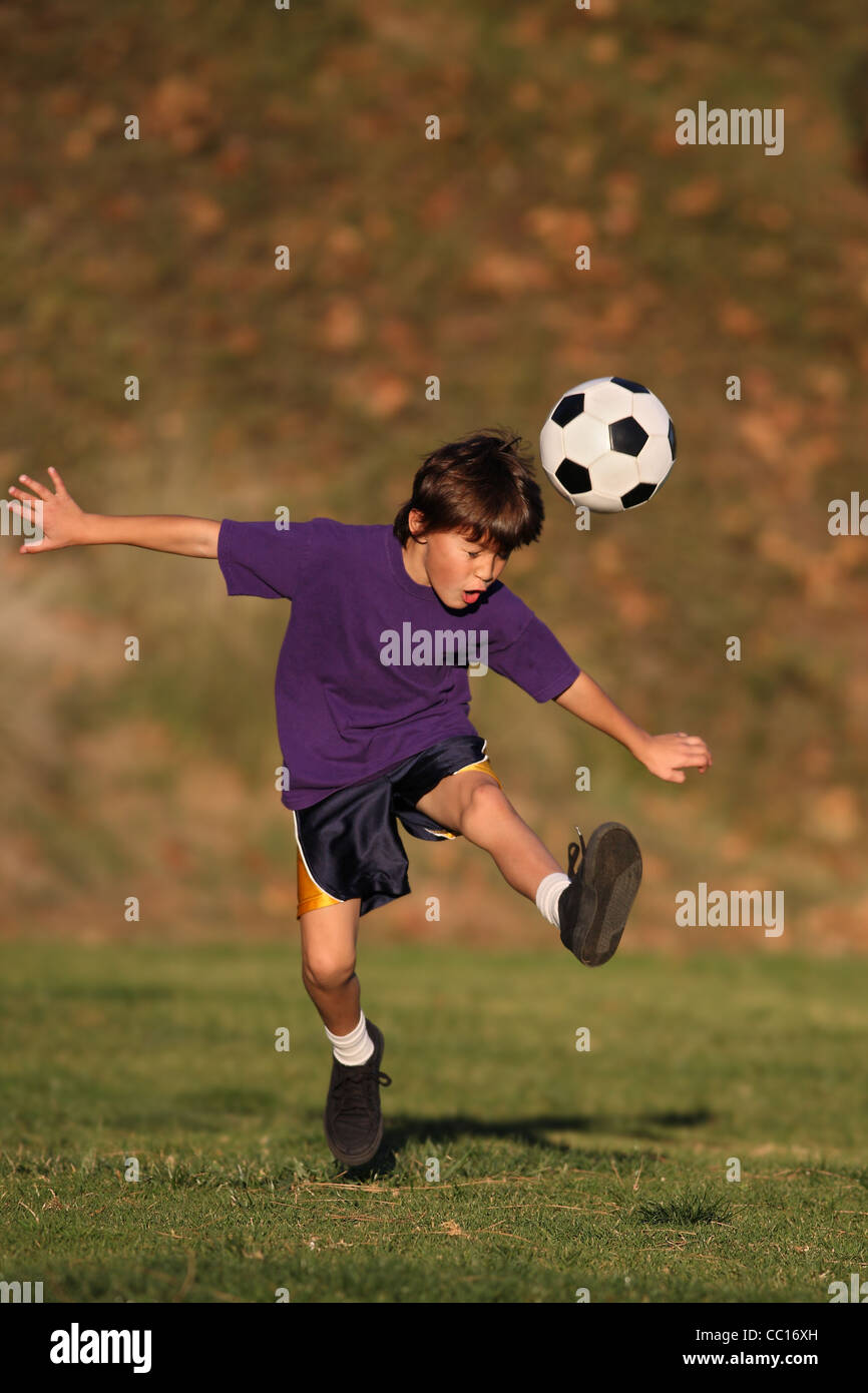 Child kicking foot ball hi-res stock photography and images - Alamy