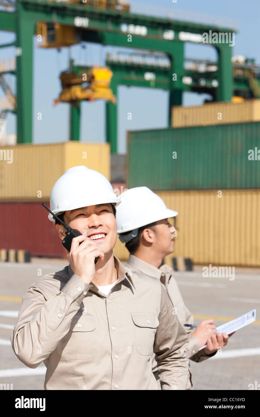 Male shipping industry workers at work Stock Photo - Alamy