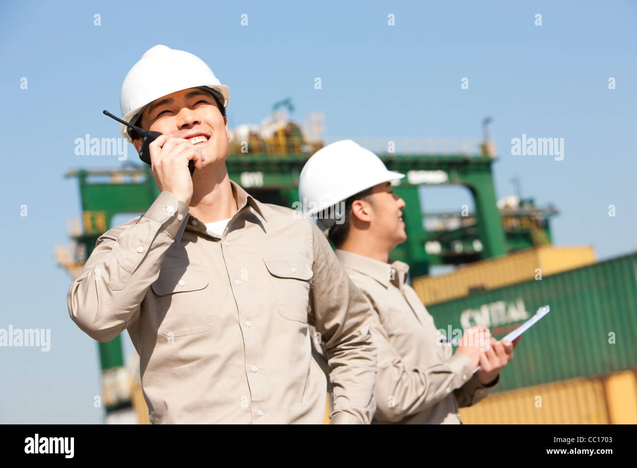 Male shipping industry workers at work Stock Photo - Alamy