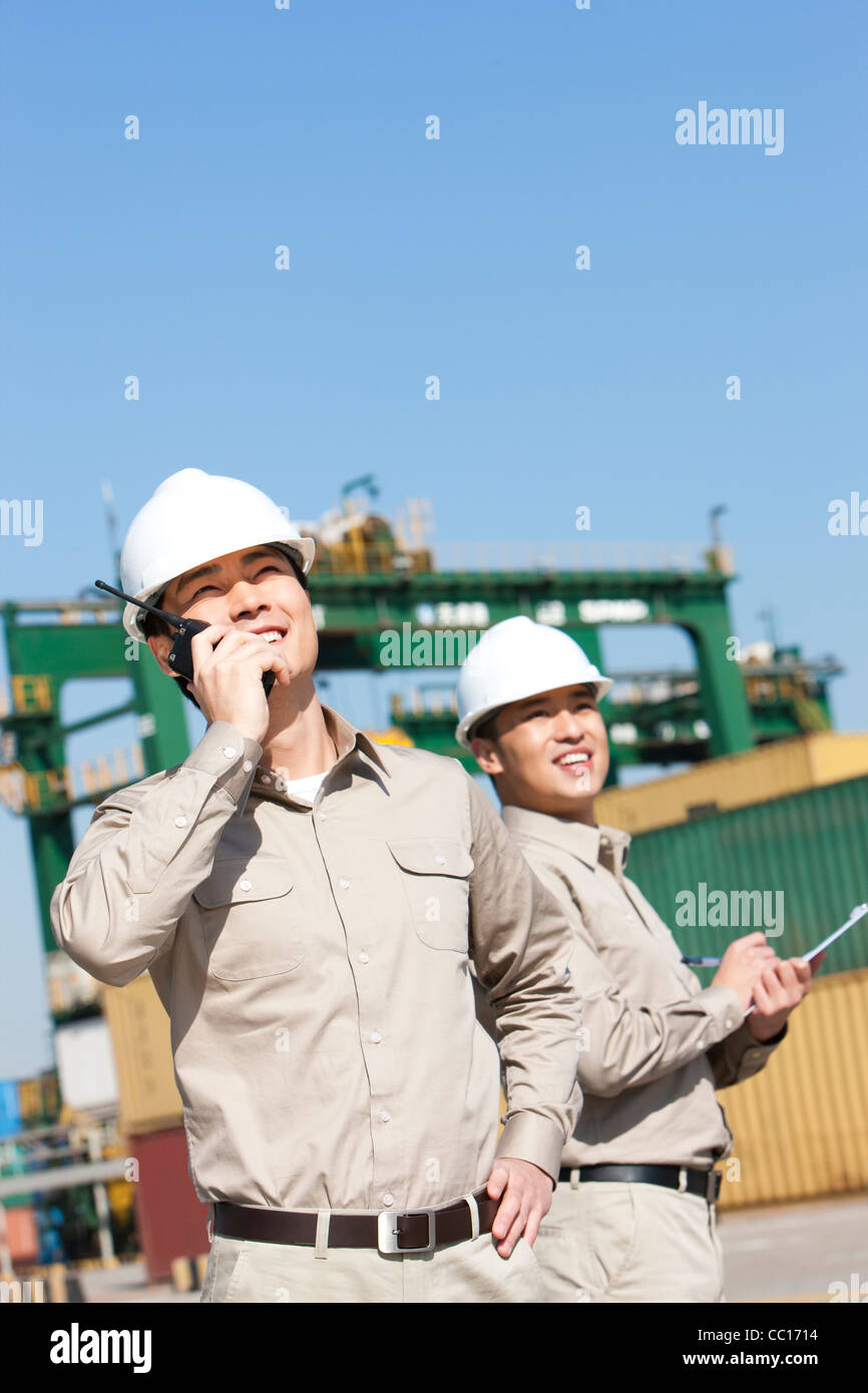 Male shipping industry workers at work Stock Photo - Alamy