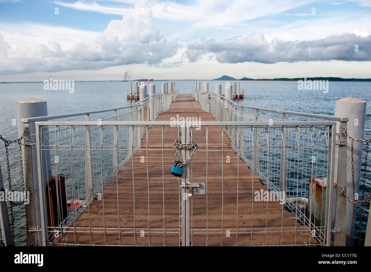 A blue lock on a grey gate with a pier leading into the distance Stock ...