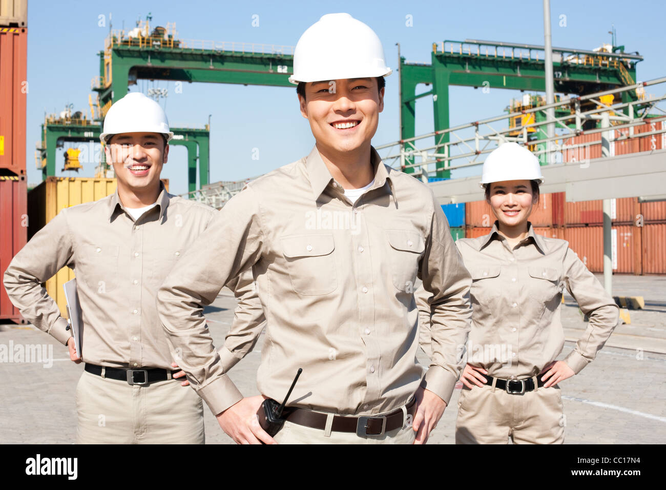 shipping industry workers with hands on their hips Stock Photo - Alamy