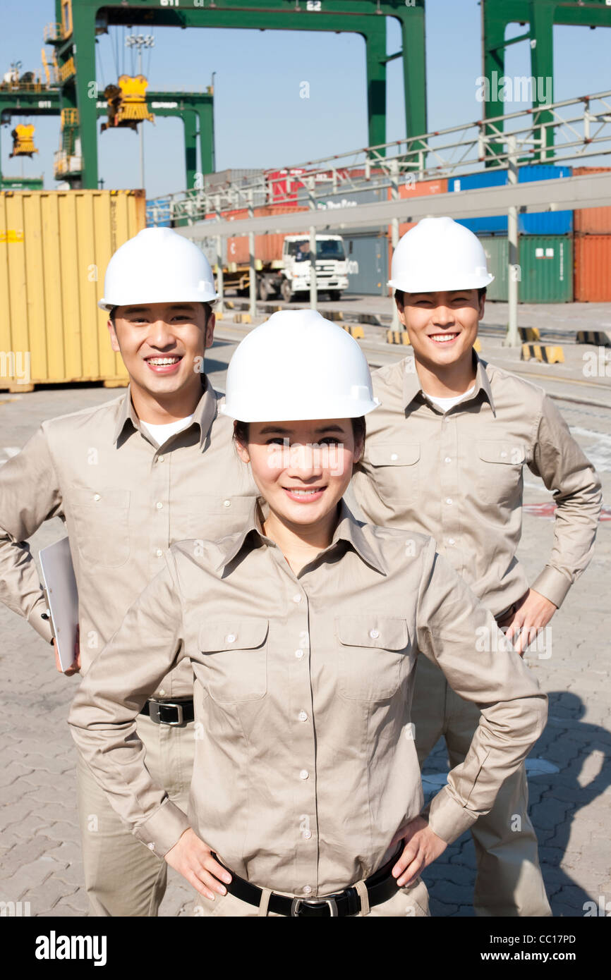 shipping industry workers with hands on their hips Stock Photo - Alamy