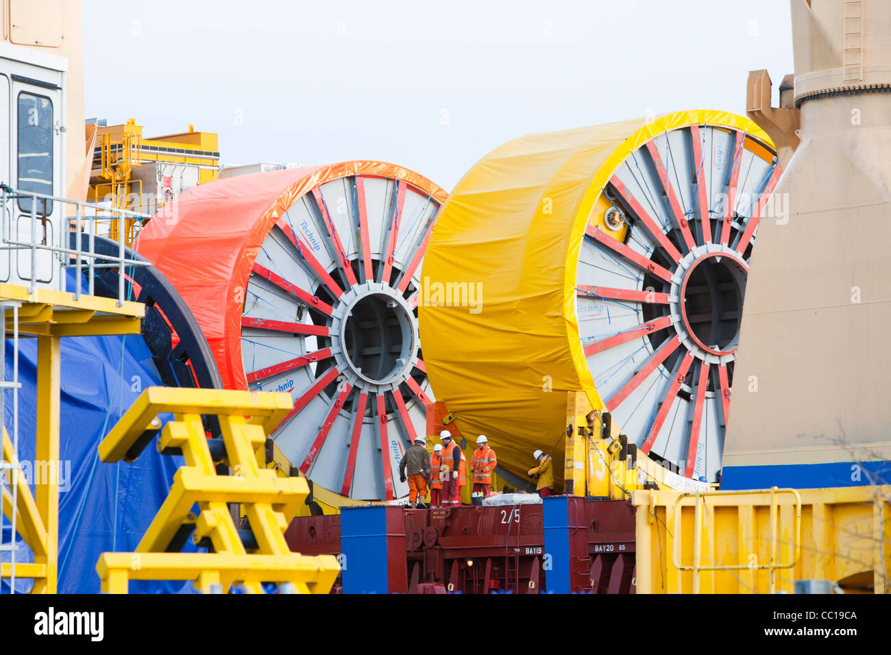 A crane lifting offshore cabling onto a ship at Duco Ltd, an offshore ...