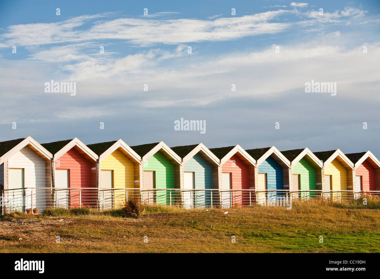 Colourful traditional British seaside beach huts on the beach in Blyth ...