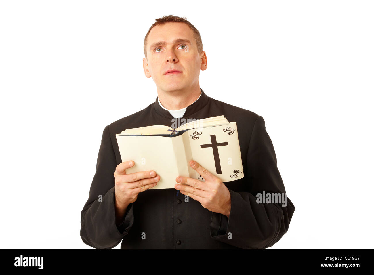 Young priest with bilbe in his hands looking upwards Stock Photo - Alamy