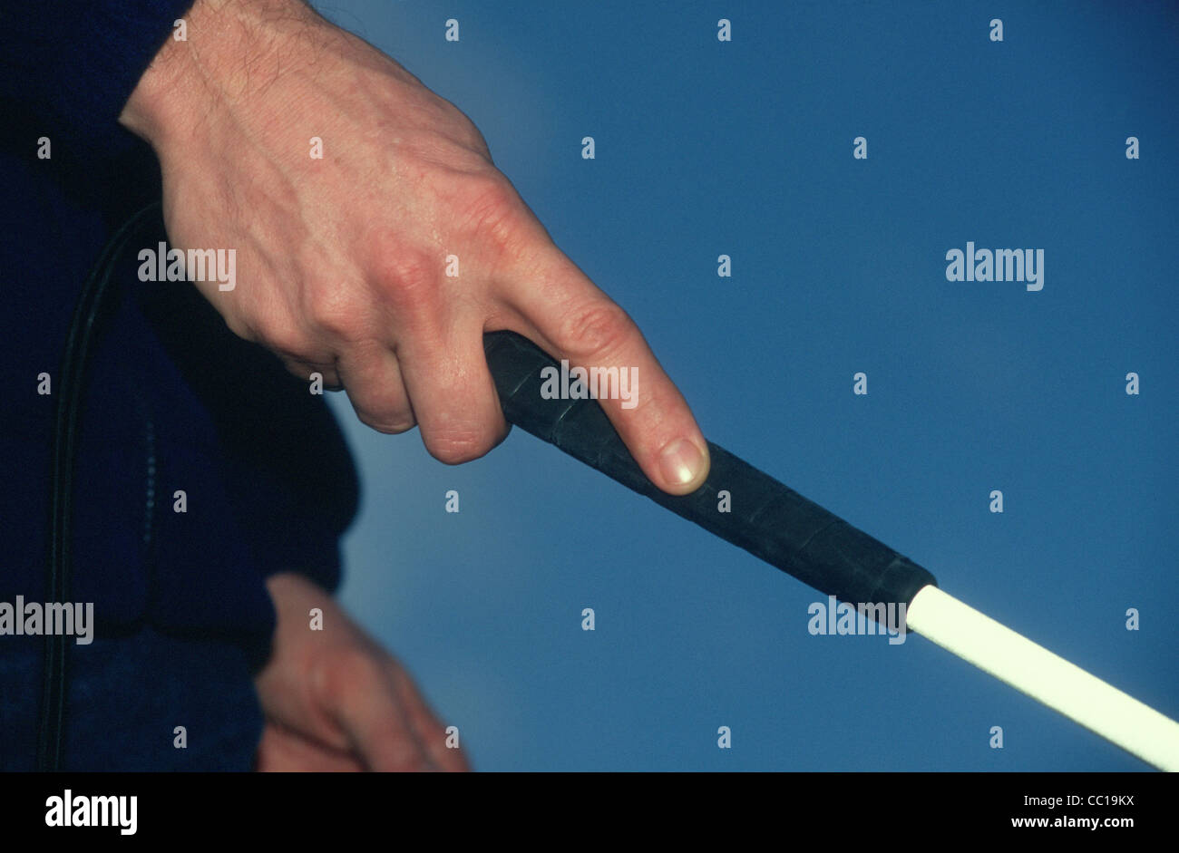 Blind person demonstrating the correct way to grasp a long cane to aid ...