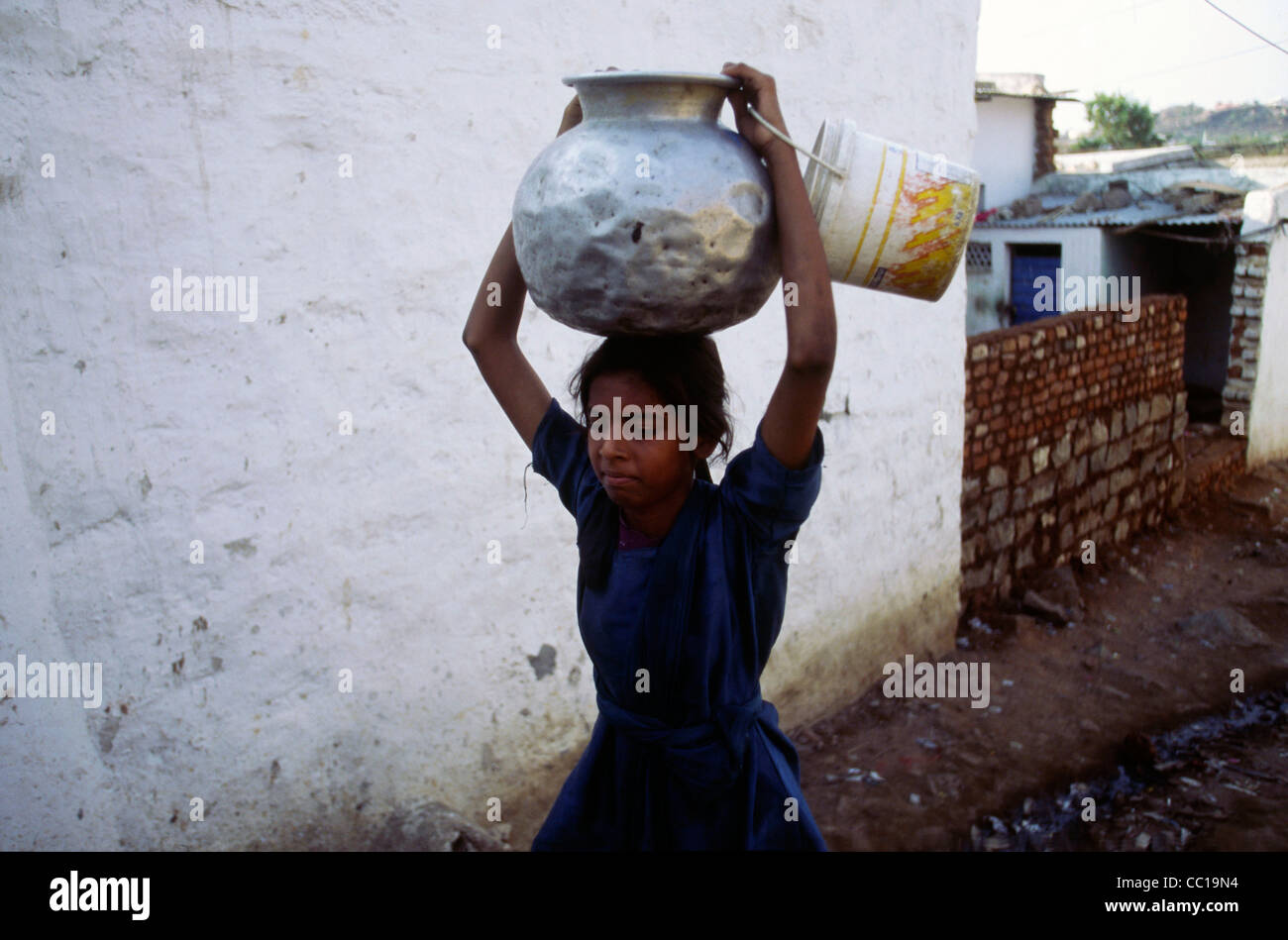 Girl child carry water bucket hi-res stock photography and images - Alamy