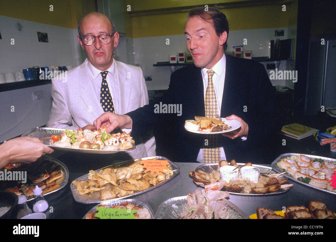 Simon Hughes MP (right) sampling the food at the opening of a centre ...