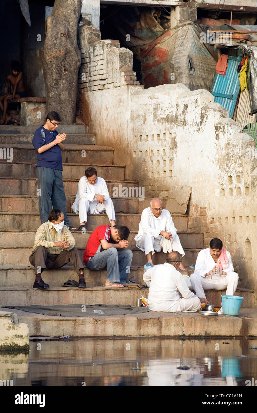A group of men scatter the cremated ashes of a family member in the ...