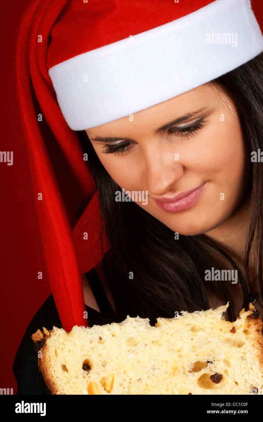Beautiful 18 years old Santa Claus girl eating panettone, the italian ...