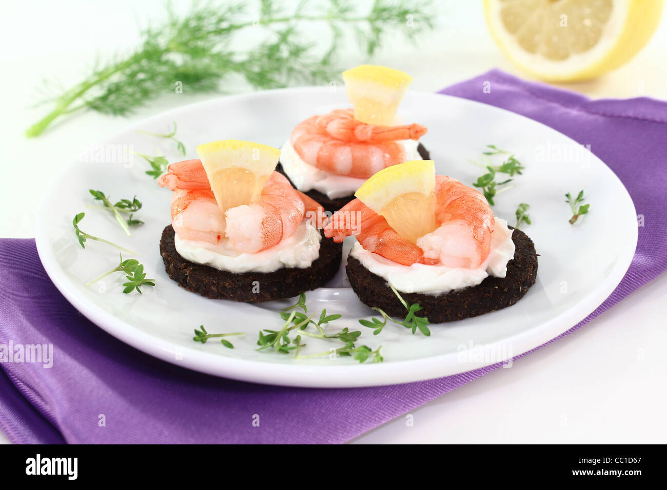 Canapés with shrimp, lemon and garden cress Stock Photo - Alamy
