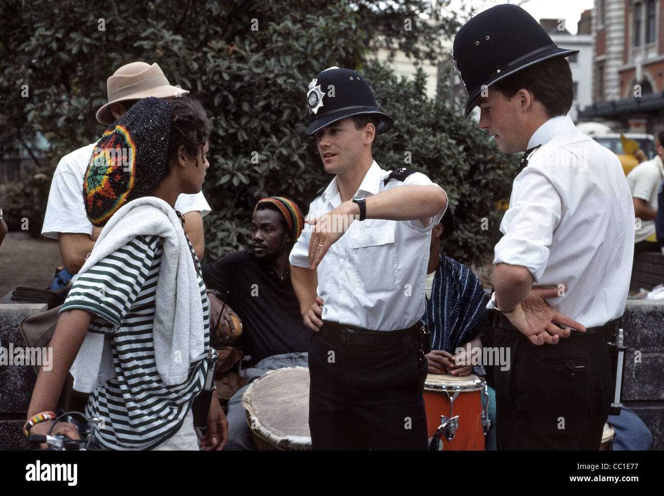 young policman speaking to Afro-Caribbean woman with dreadlocks Stock ...