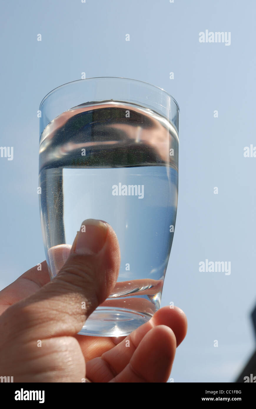 Hand holding glass of water Stock Photo - Alamy