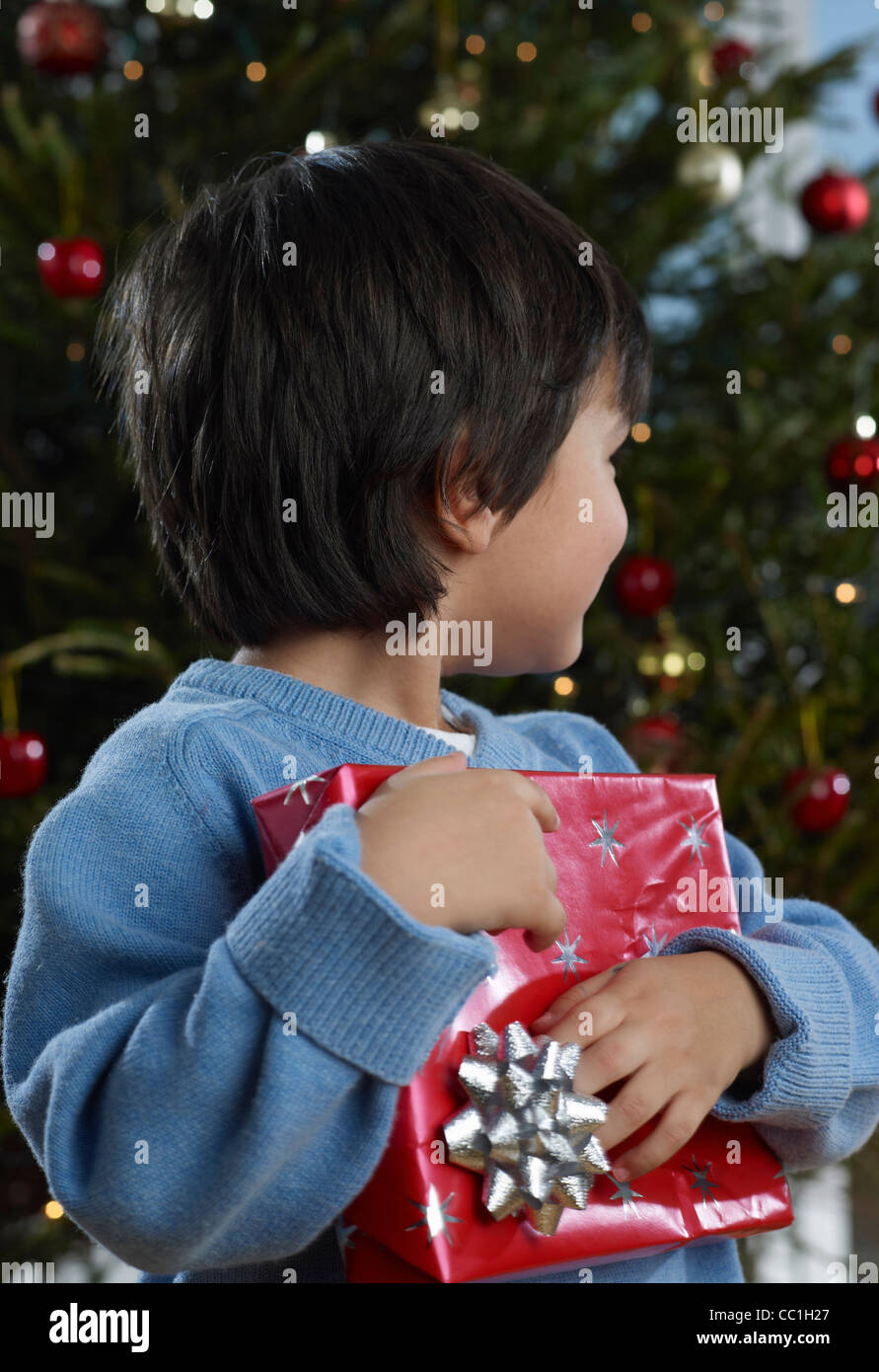 boy holding christmas present Stock Photo - Alamy