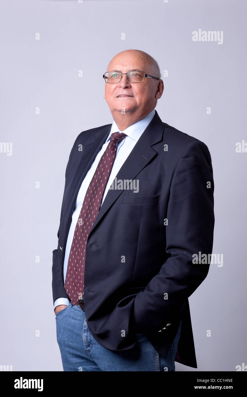 portrait of a successful senior man on gray background Stock Photo - Alamy