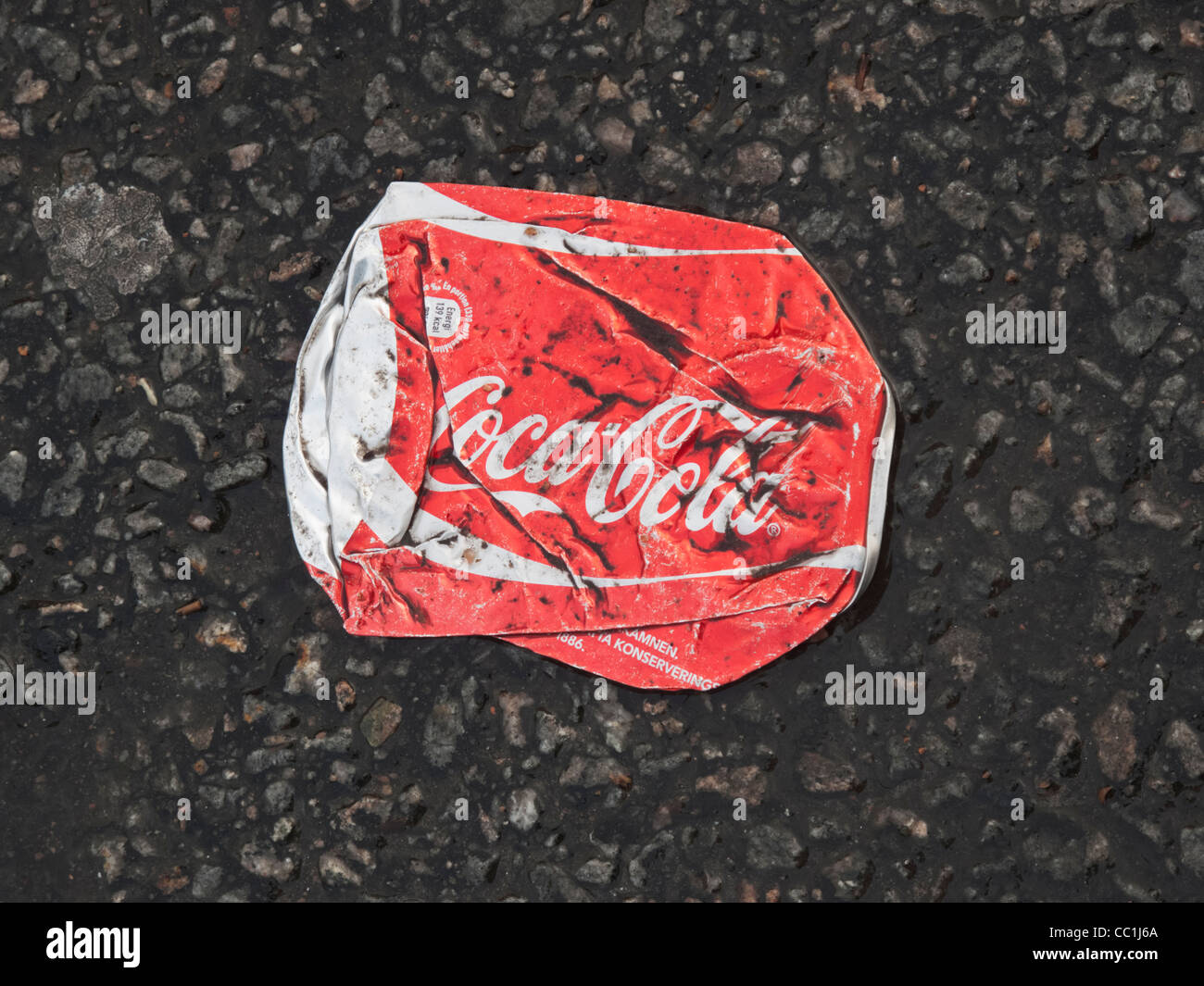 Flat, dirty and wrinkled Coca-Cola aluminum can on the street. FOR ...