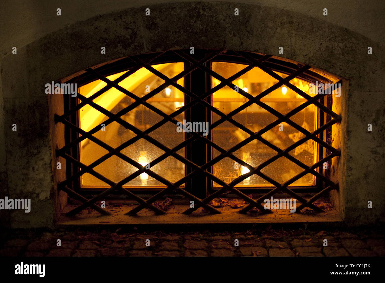 Looking into a traditional cross-bared basement window. Inside golden ...