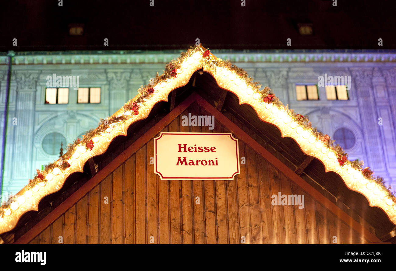 The peak of a Christmas Market hut selling hot/roasted Chestnuts sits ...