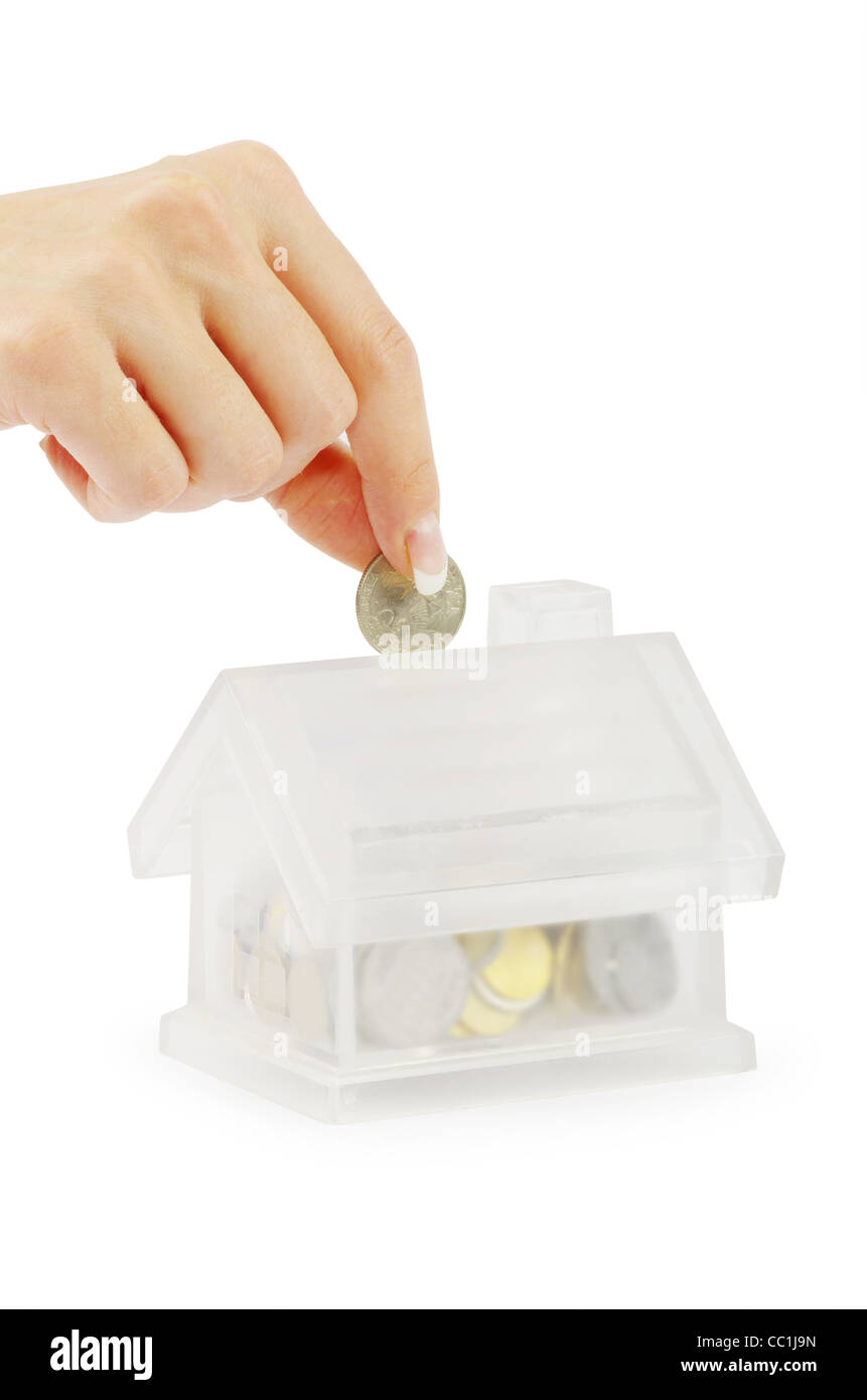 Hand with coin and house bank isolated on white background Stock Photo ...